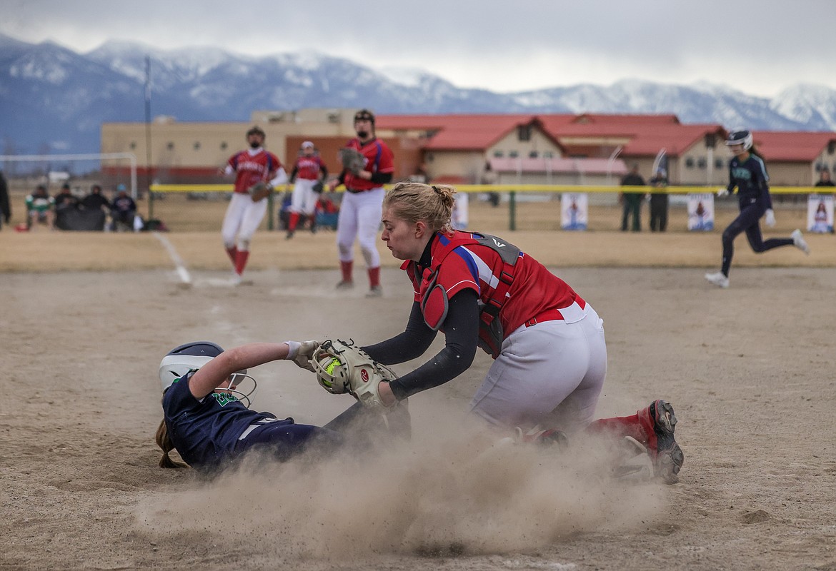Softball Players Sliding